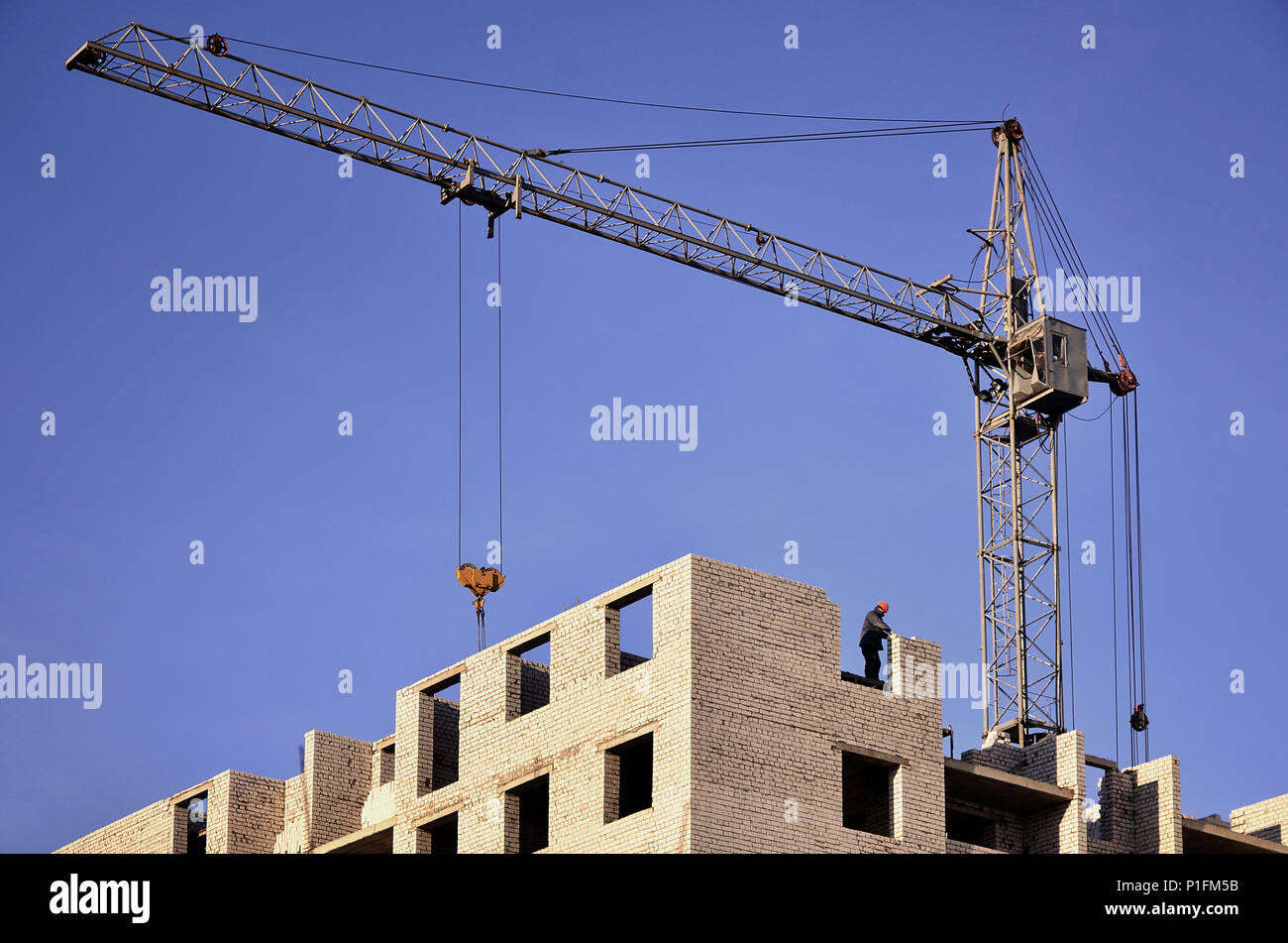 Working tall cranes inside place for with tall buildings under ...