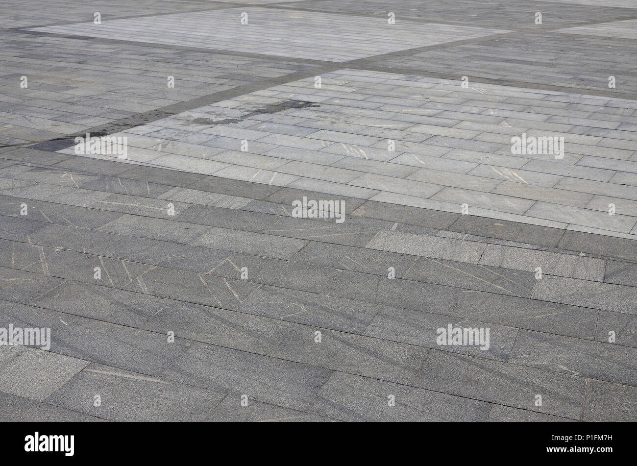 The texture of granite paving tiles from a variety of square shaped ...