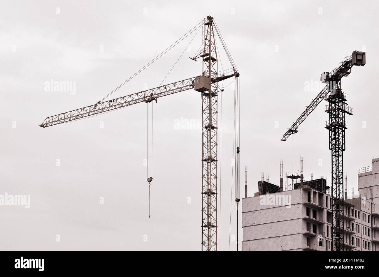 Working tall cranes inside place for with tall buildings under ...