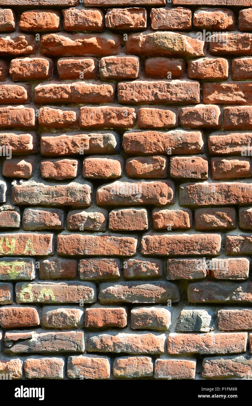 Vertical wall texture of several rows of very old brickwork made of red ...