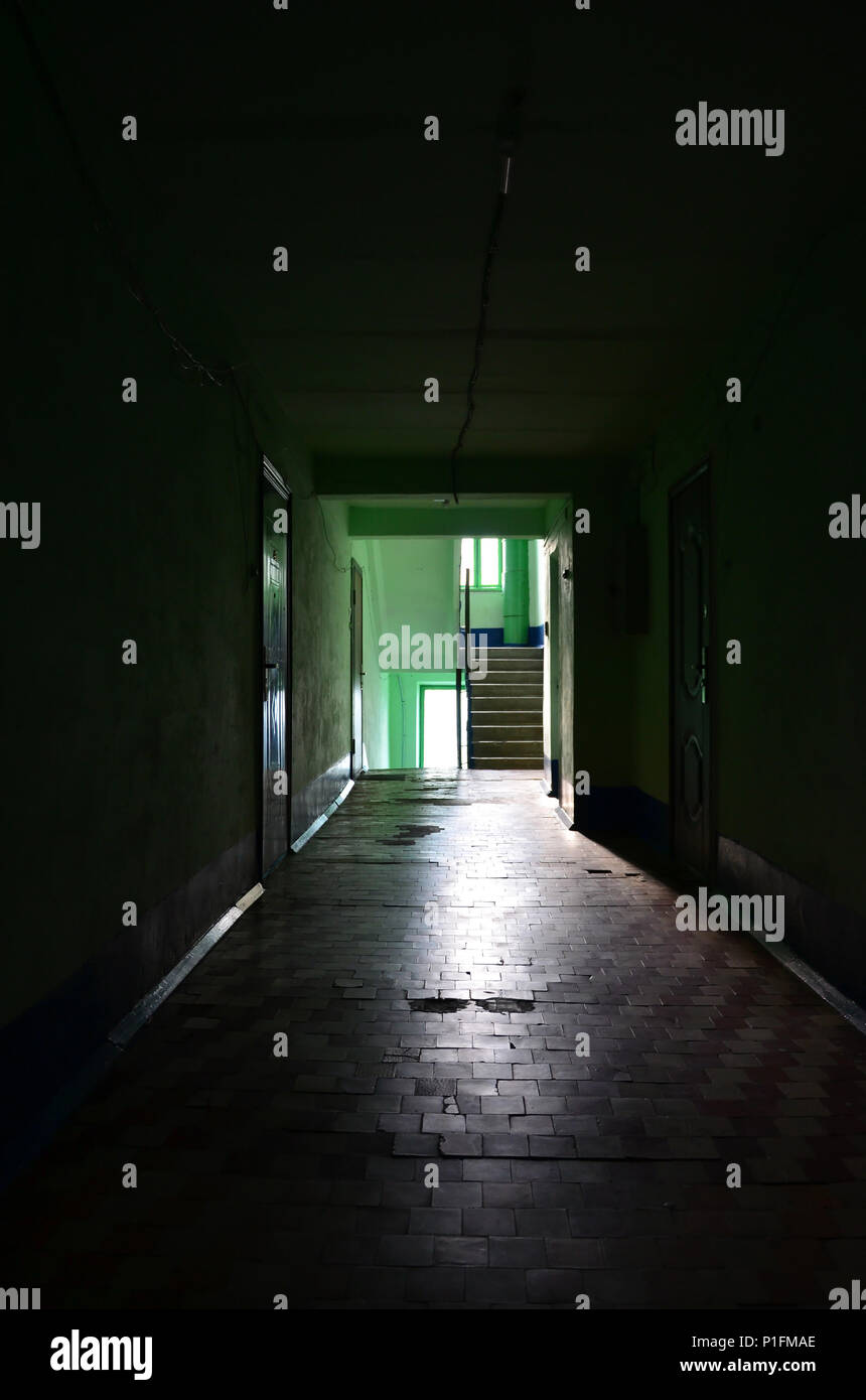 The gloomy corridor of a neglected public building. Public space in a ...