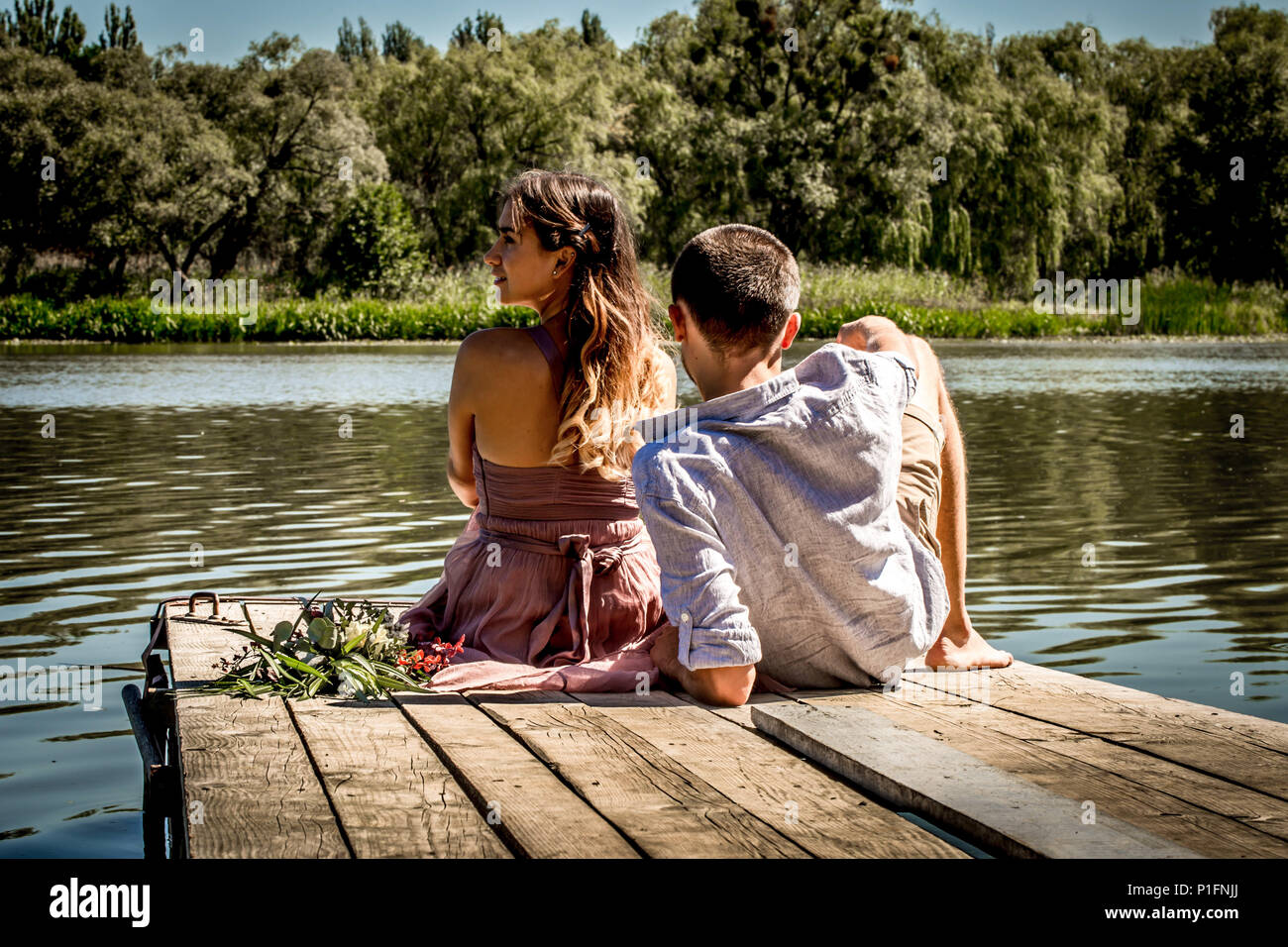 beautiful love young couple on the pier near the river Stock Photo - Alamy