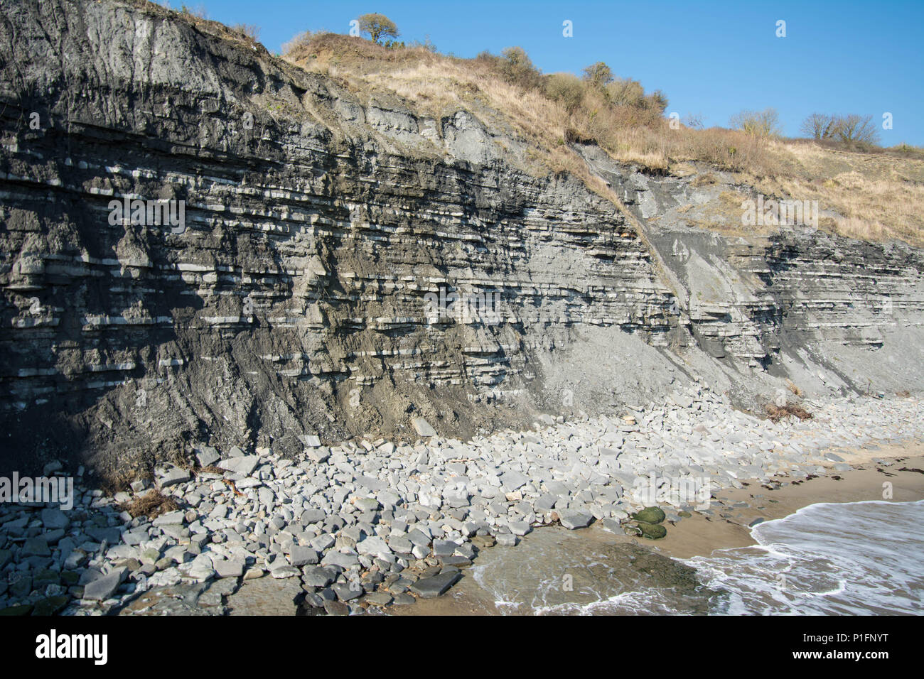 Lime Regis England cliff edge cut old stone stones beach danger eroding ...