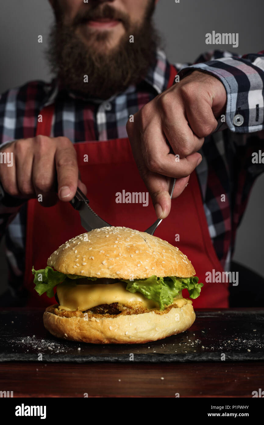 Man eating fresh self made burger close up Stock Photo - Alamy