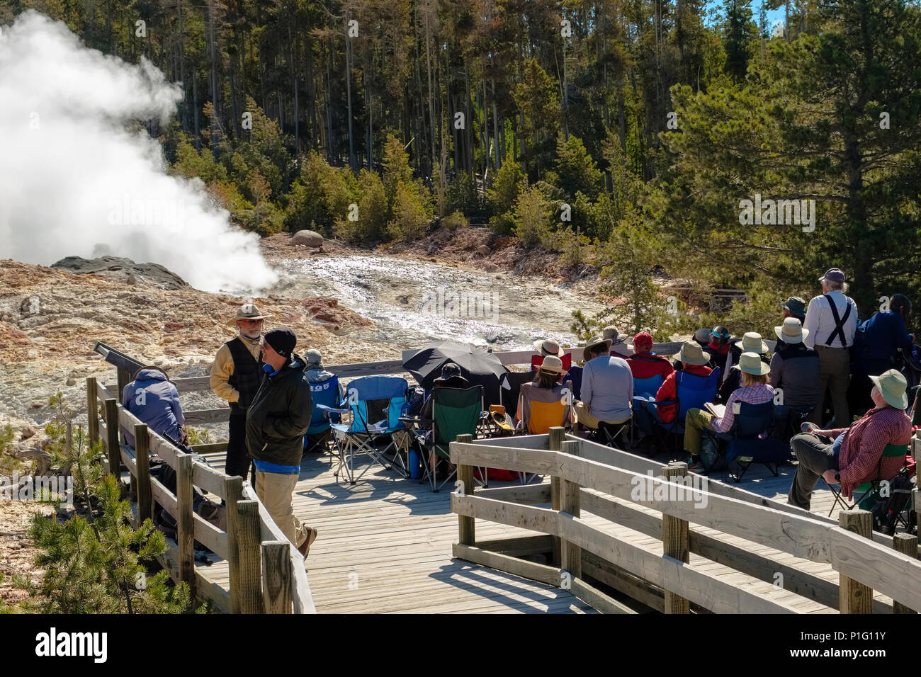 Group of tourists waiting for Steamboat Geyser to erupt in Yellowstone ...