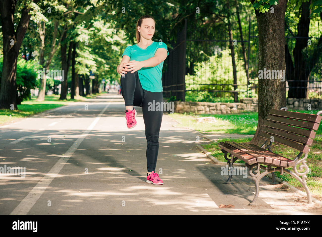 Girl working stretching leg muscles warm up Stock Photo - Alamy