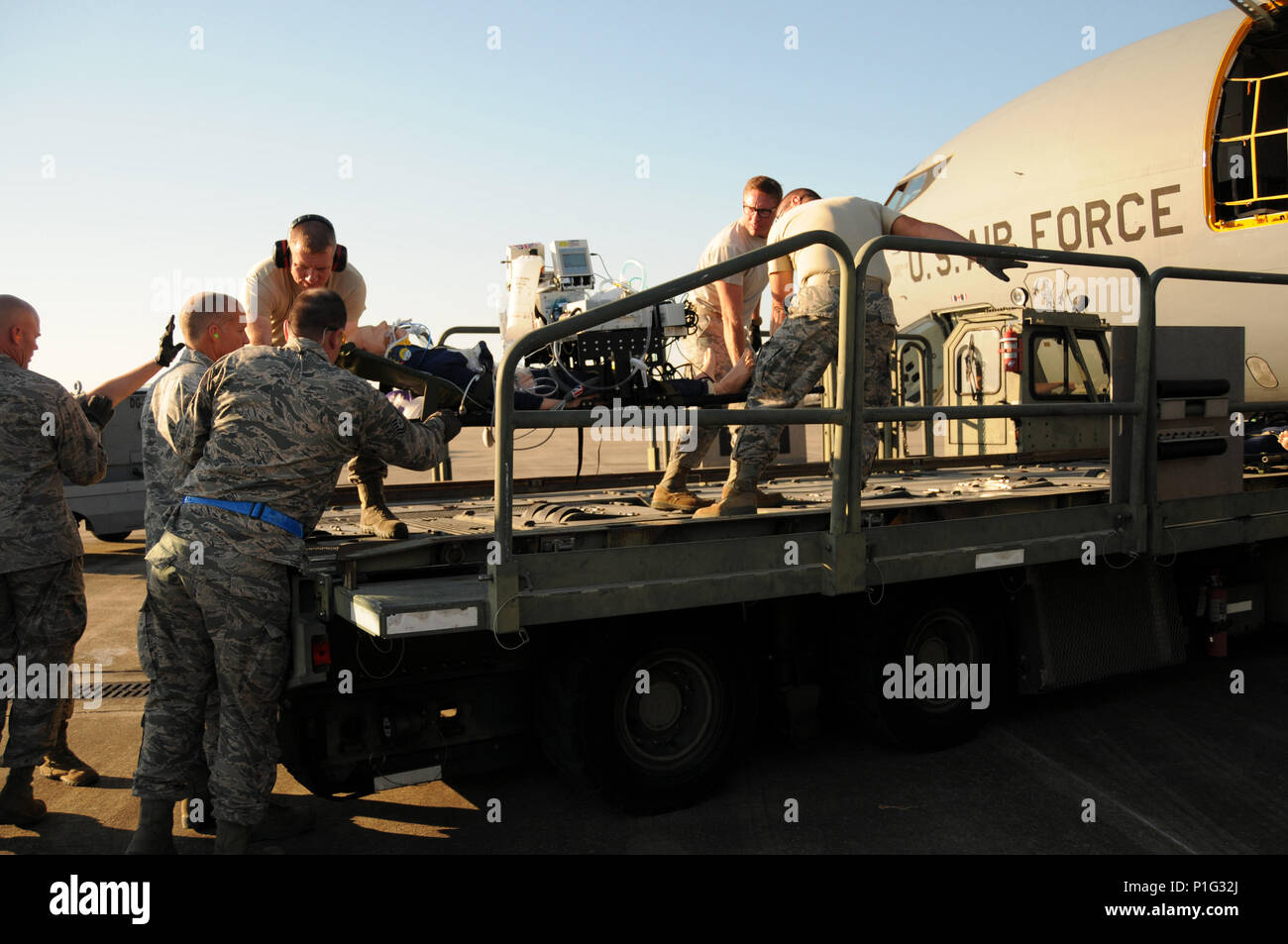 U.S. Air Force Airmen with the 172d Airlift Wing, use a K-Loader to ...