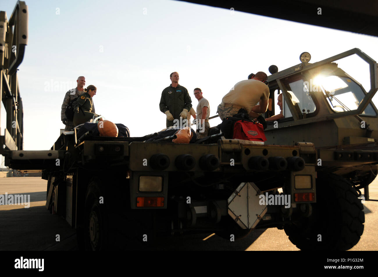 U.S. Air Force Airmen with the 172d Airlift Wing, use a K-Loader to ...