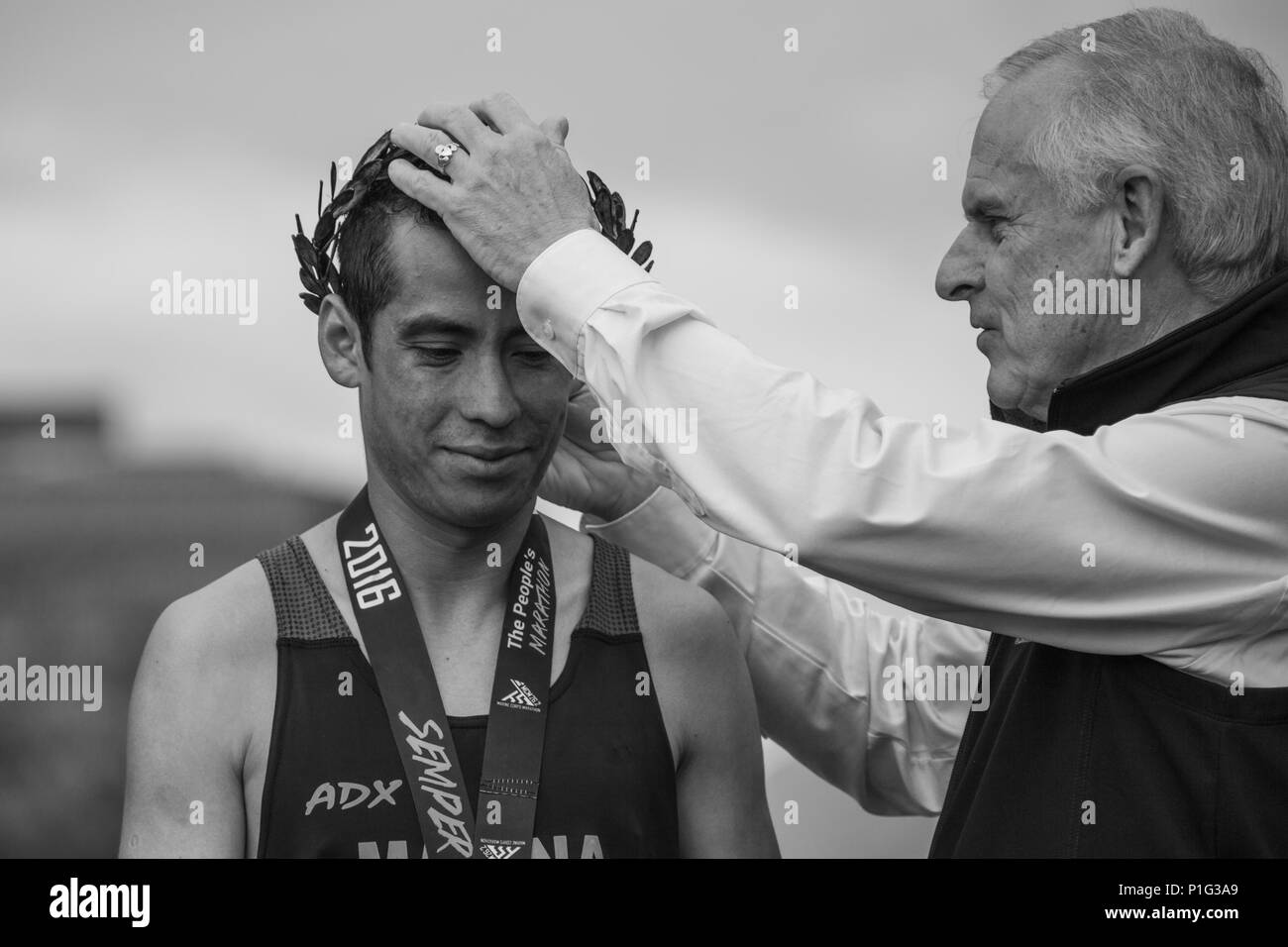 Tim Kilduff, executive director of the 26.2 Foundation, right, places a ...