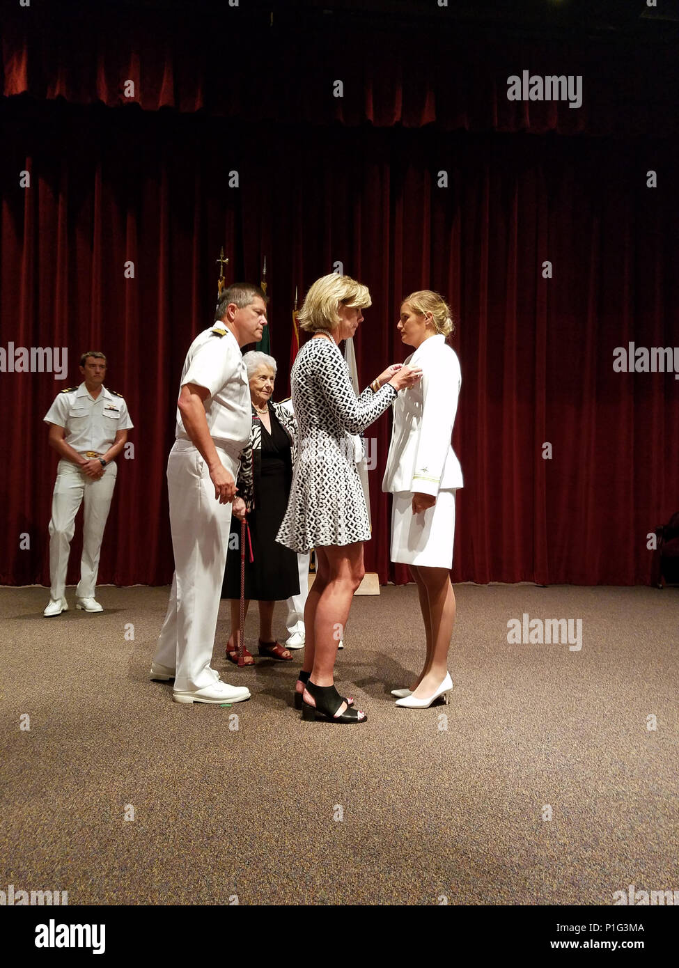 Lt. j.g. Audrey Petersen is pinned with her wings of gold by her mother ...