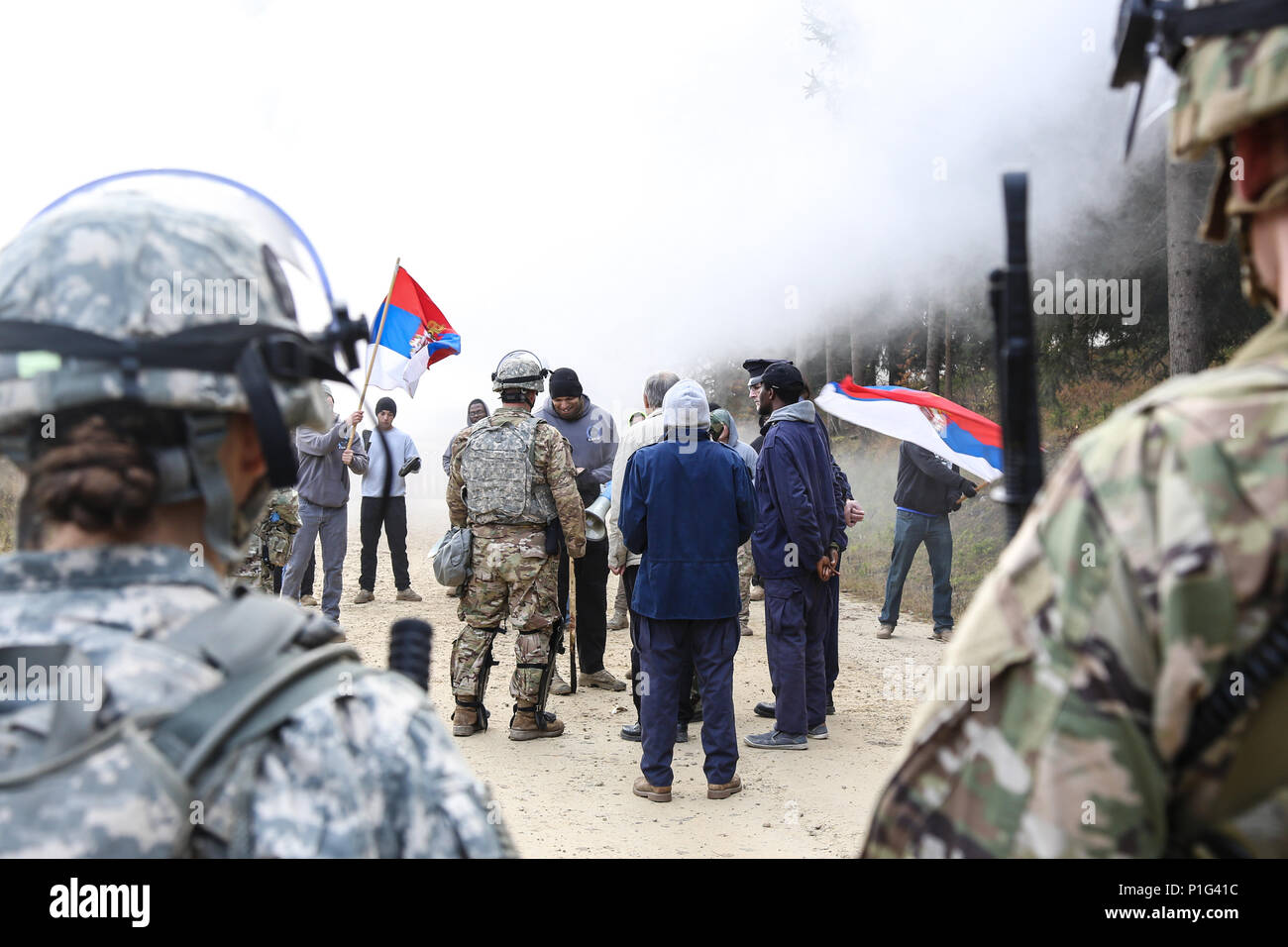 A U.S. Soldier, center left, of 1st Squadron, 33rd Cavalry Regiment ...