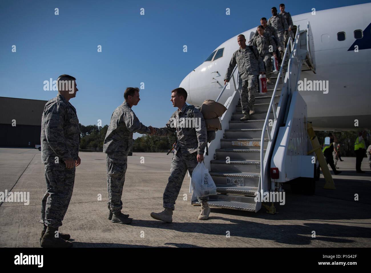 Airmen assigned to the 822d Base Defense Squadron are greeted by Col ...