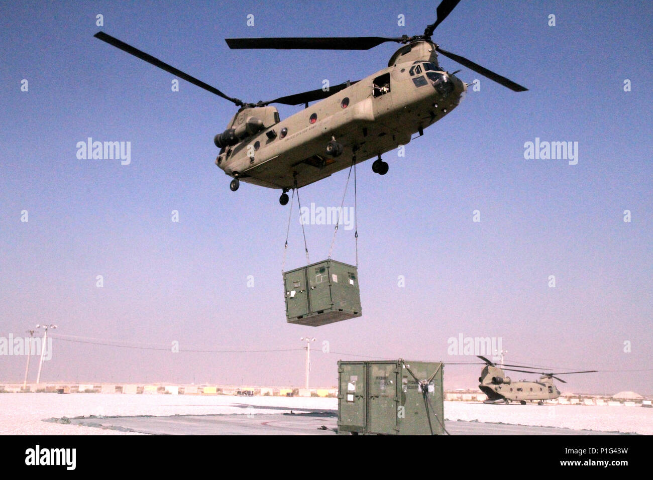A CH-47 Chinook helicopter takes off from Bagram Airfield, Oct. 27, with a CONNEX sling loaded ...