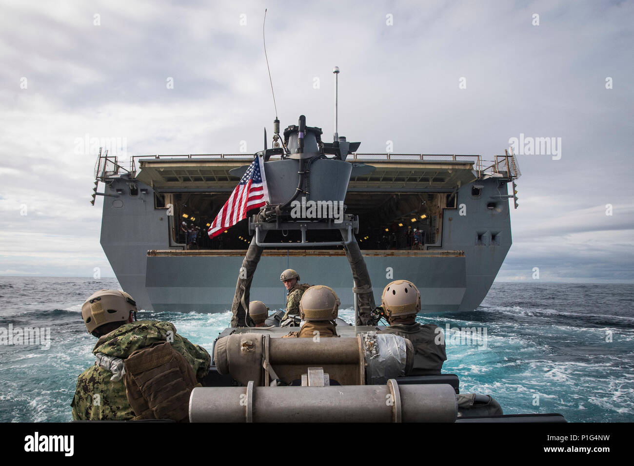 U.S. Navy divers assigned to Explosive Ordnance Disposal Mobile Unit 3 ...
