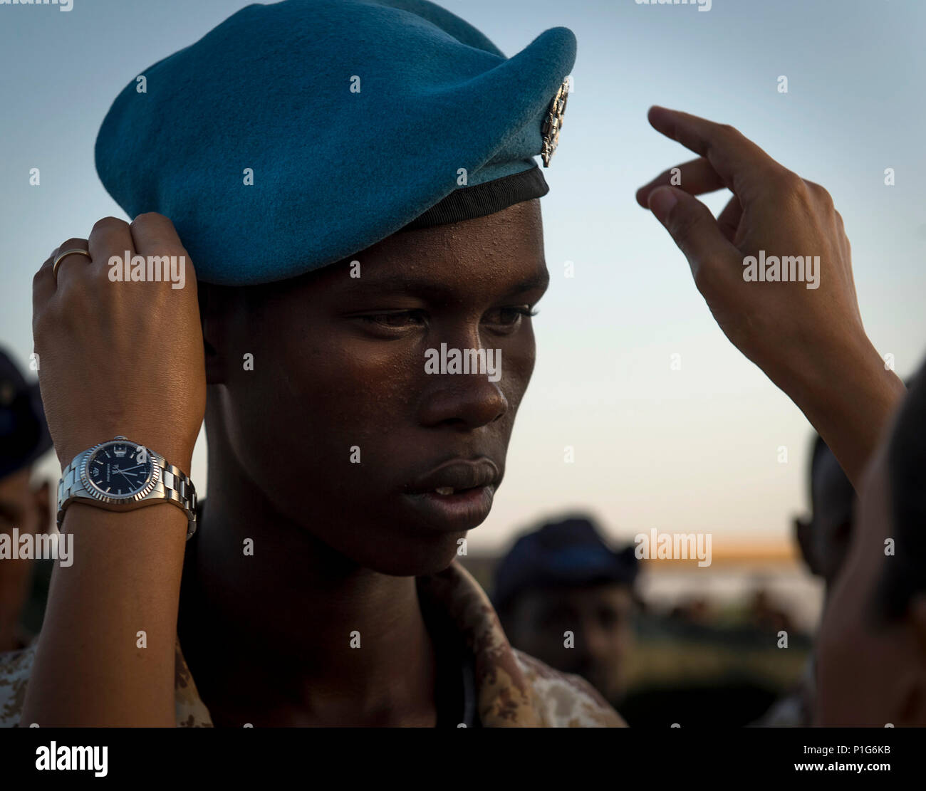 A member of the Somali Police Force has his beret adjusted by a member ...