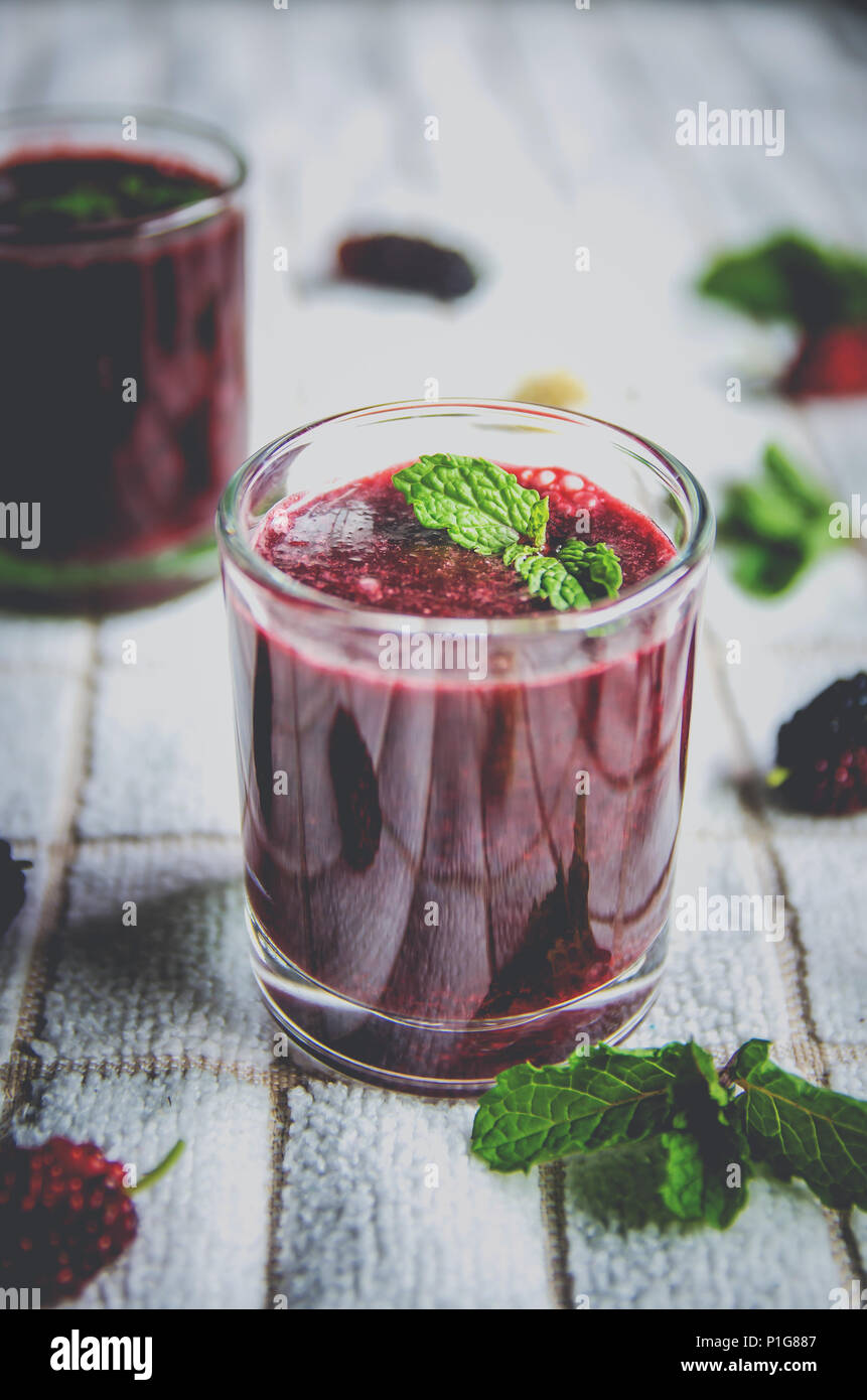 Close-up of mulberry juice and mulberry fruit, Fresh berry fruit and ...