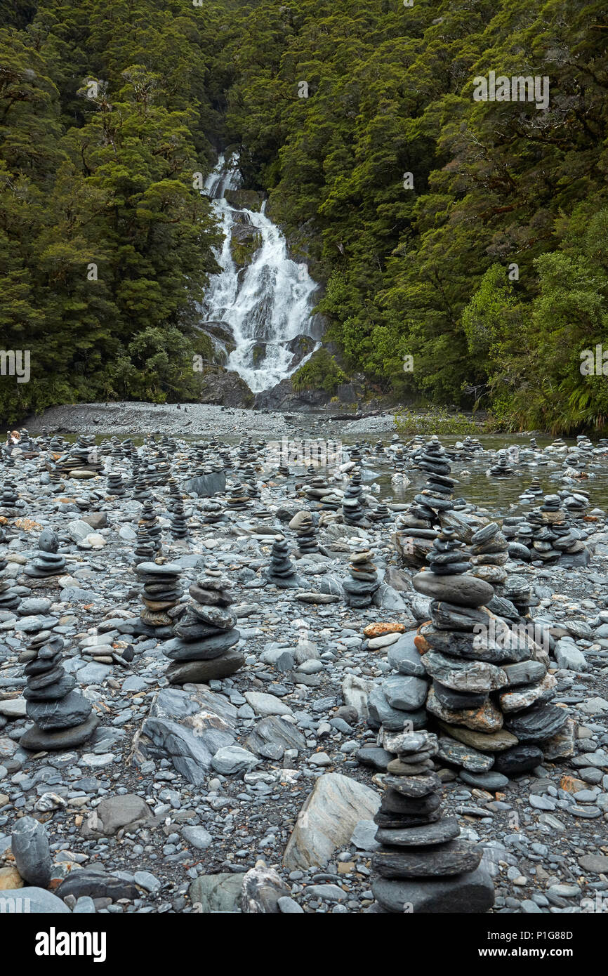 Fantail Falls and rock stacks made by tourists, Haast Pass, Mt Aspiring ...