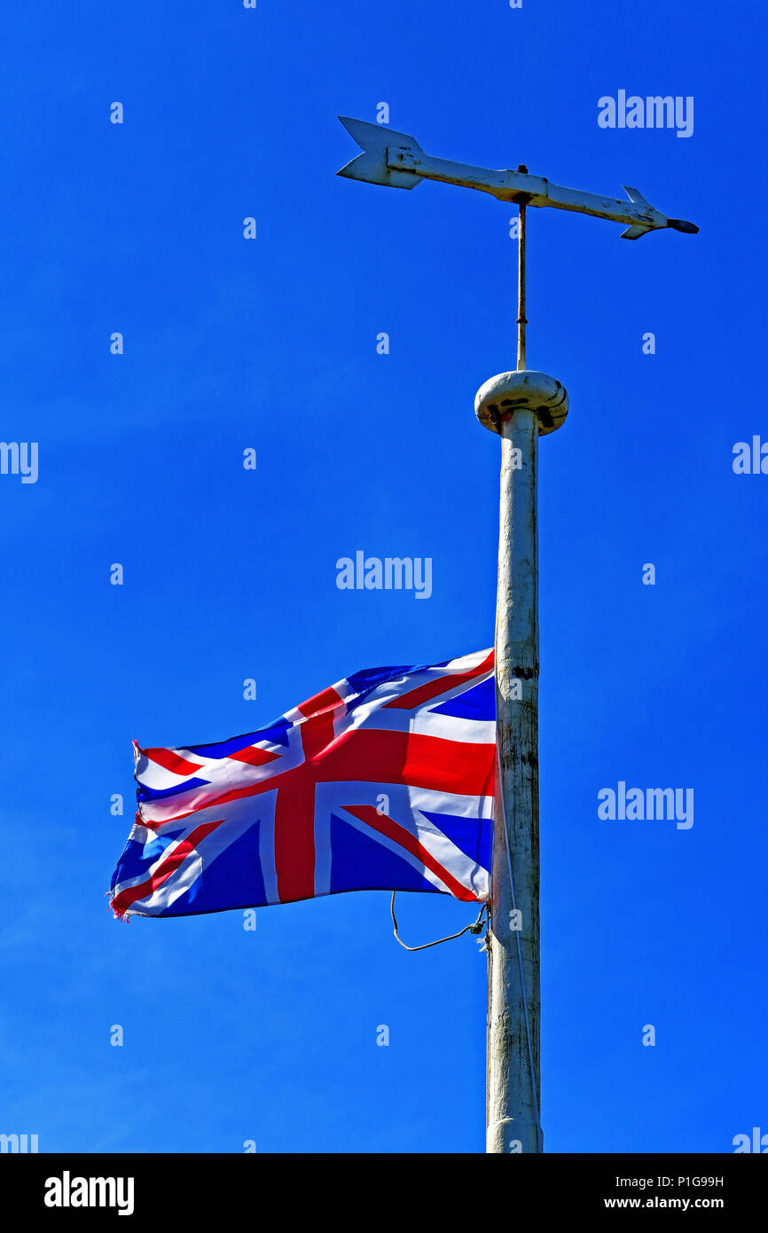Union flag on flagpole with arrow wind vane Stock Photo - Alamy