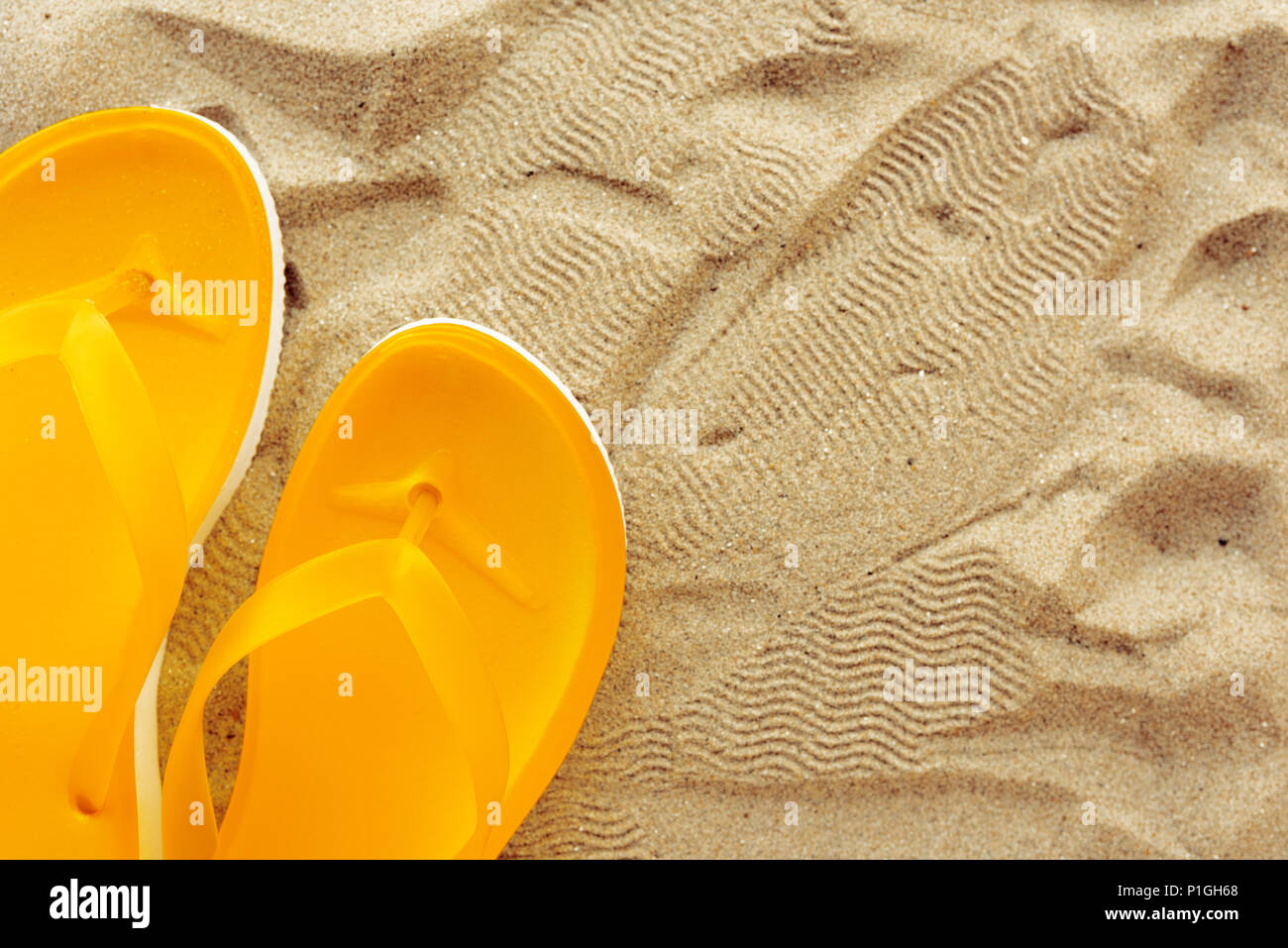 Yellow beach flip flops on sand, top view with copy space Stock Photo ...