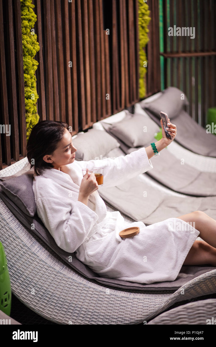 close up back side shot of young nice slim woman taking selfie in the ...