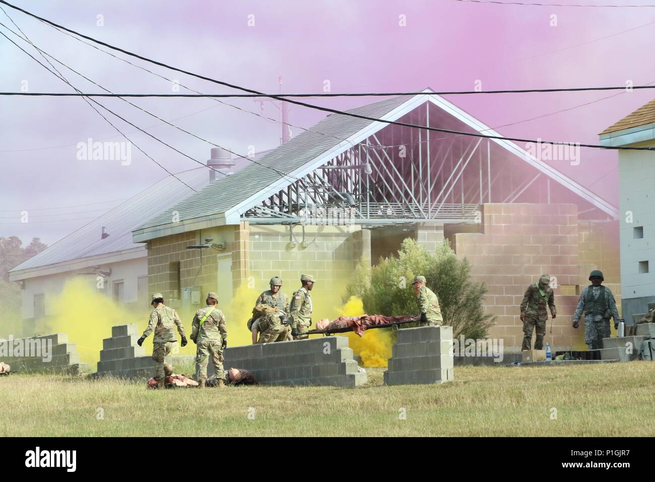 Soldiers evacuate a simulated patient during a combat scenario while ...