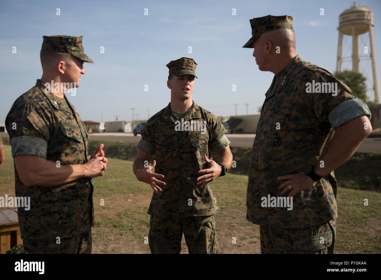 U.S. Marine Corps First Lieutenant Zachary A. Basich, center, a Marine ...