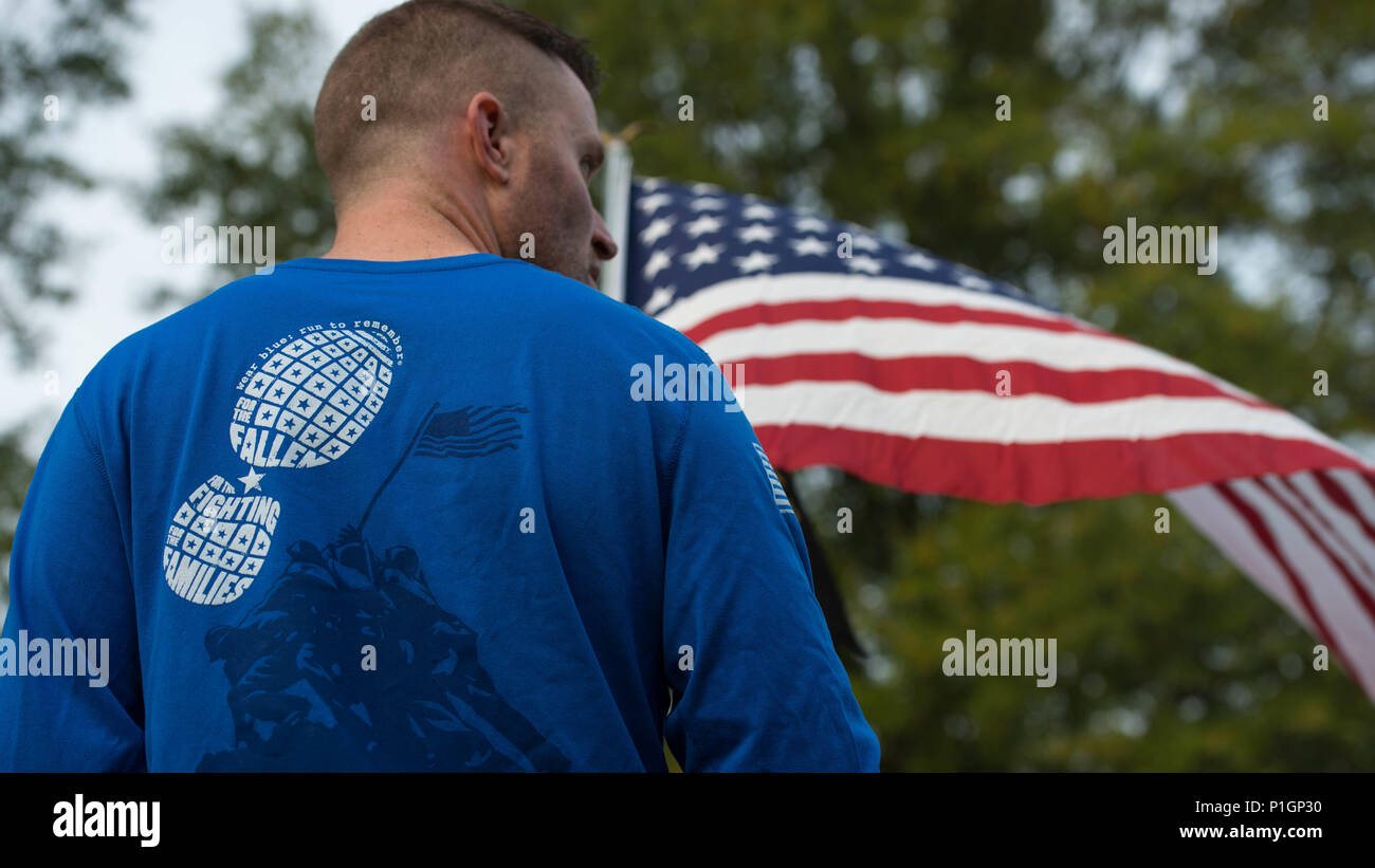 A volunteer of Wear Blue: Run to Remember hold an American flag before ...