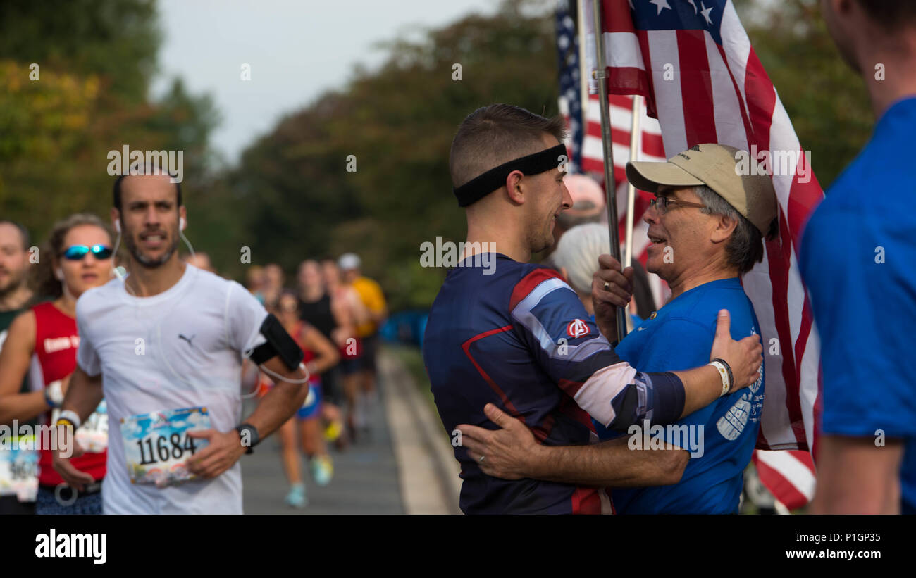 A runner is greeted by a Wear Blue volunteer during the Marine Corps ...