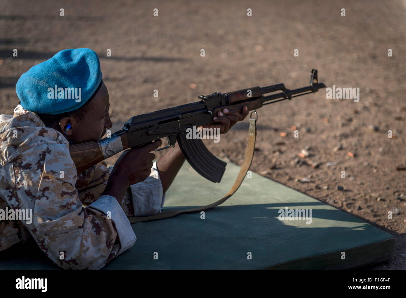 A member of the Somali Police Force fires his AK-47 rifle during range ...
