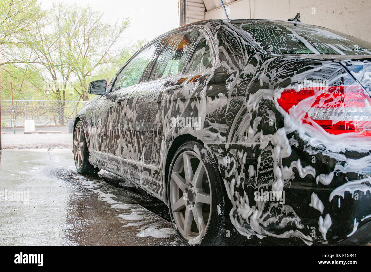 Car washing. Cleaning modern car covered by foam Stock Photo - Alamy
