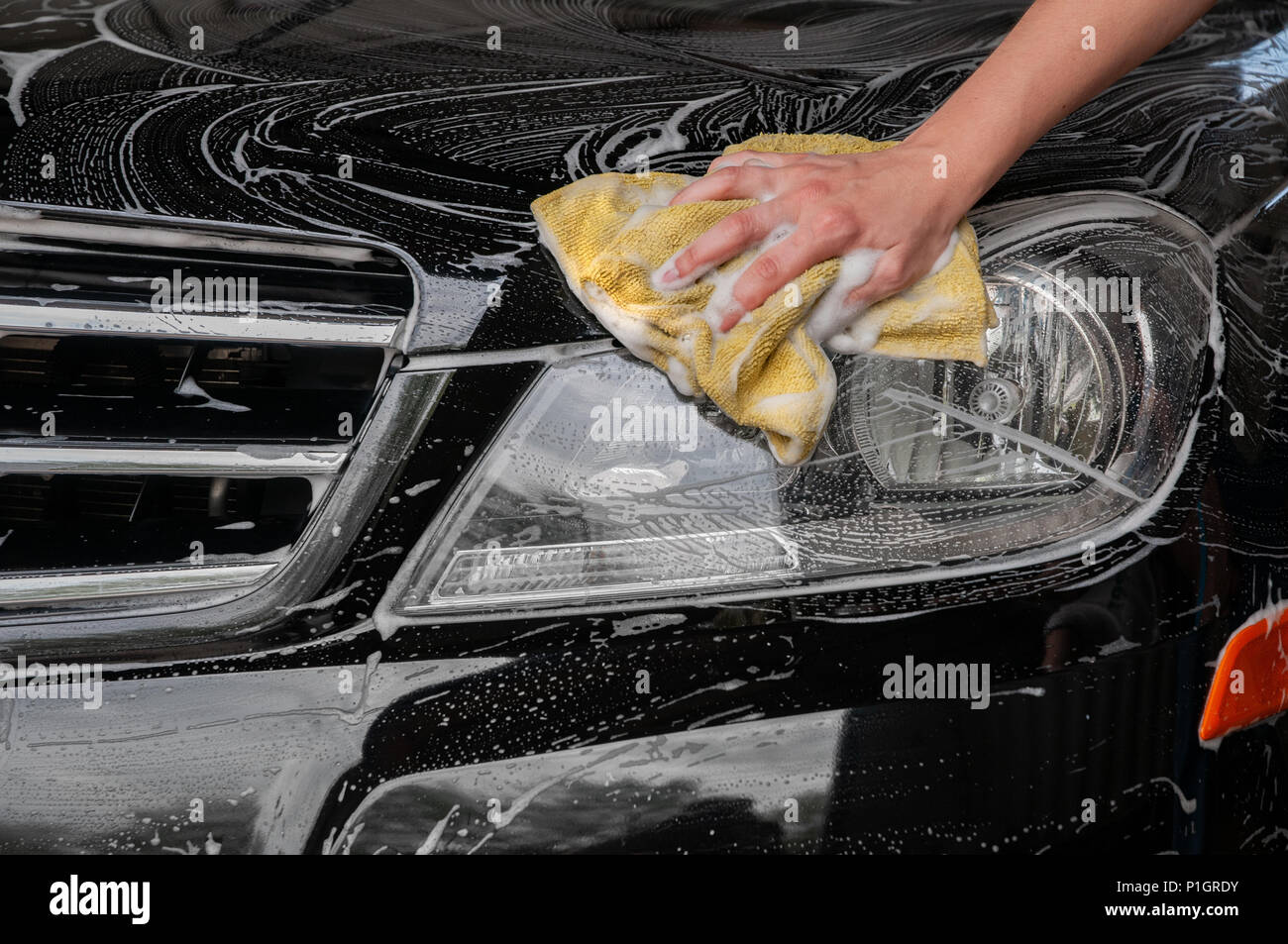 Car washing. Cleaning modern car covered by foam Stock Photo - Alamy