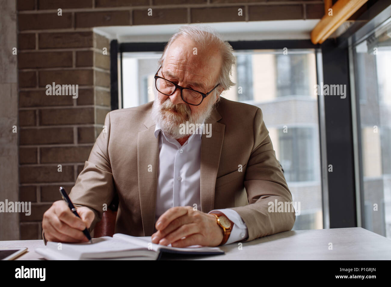 Pensive man in glasses writing hi-res stock photography and images - Alamy