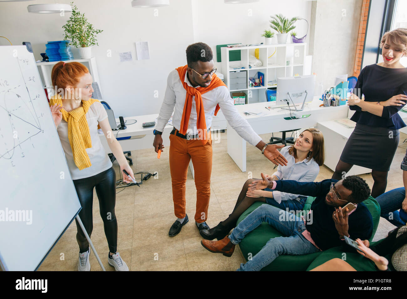 African guy with mobile phone ignoring the seminar Stock Photo - Alamy
