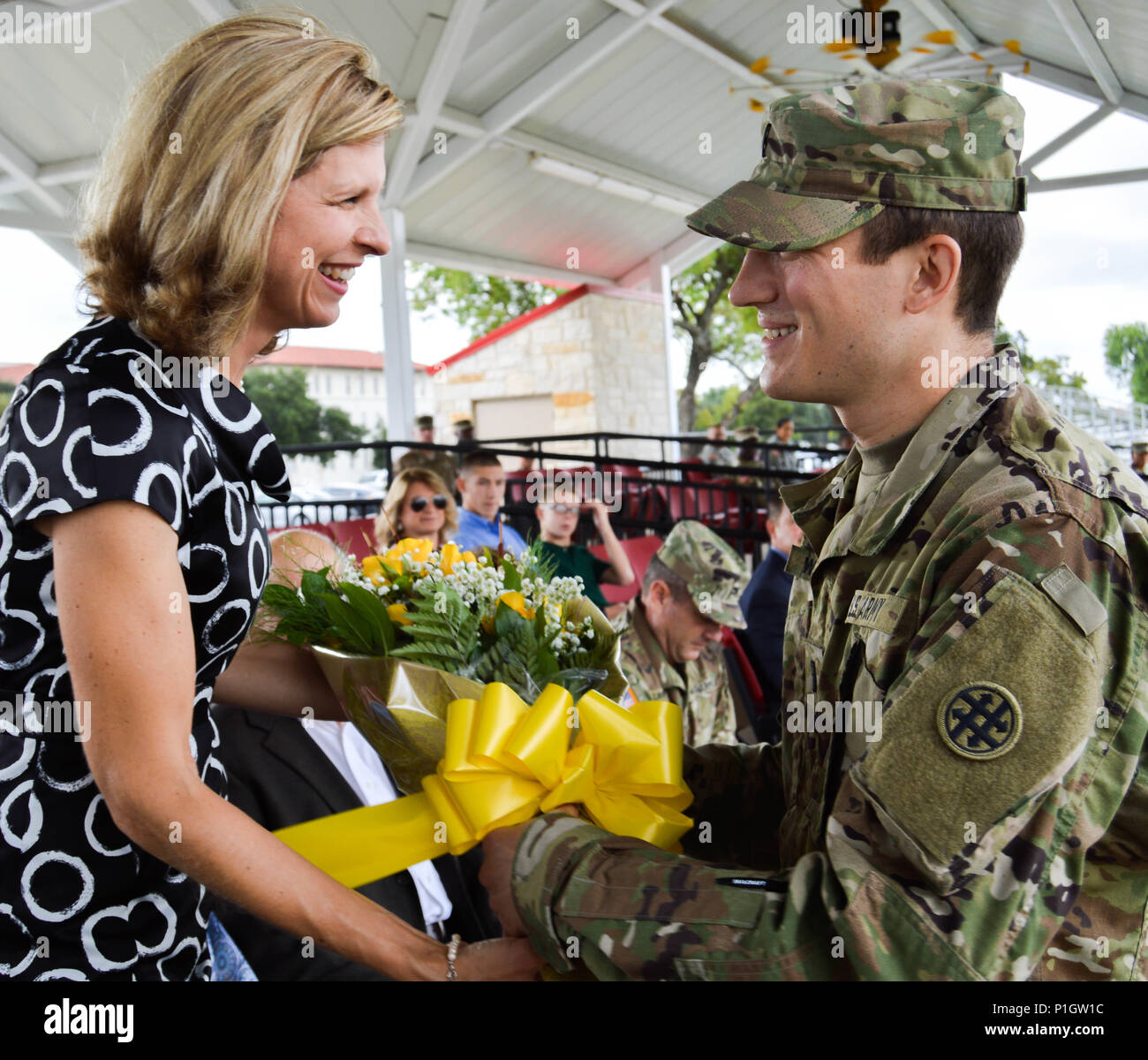 1st Lt. Matthew Wilkerson presents a bouquet of yellow roses to Brig ...