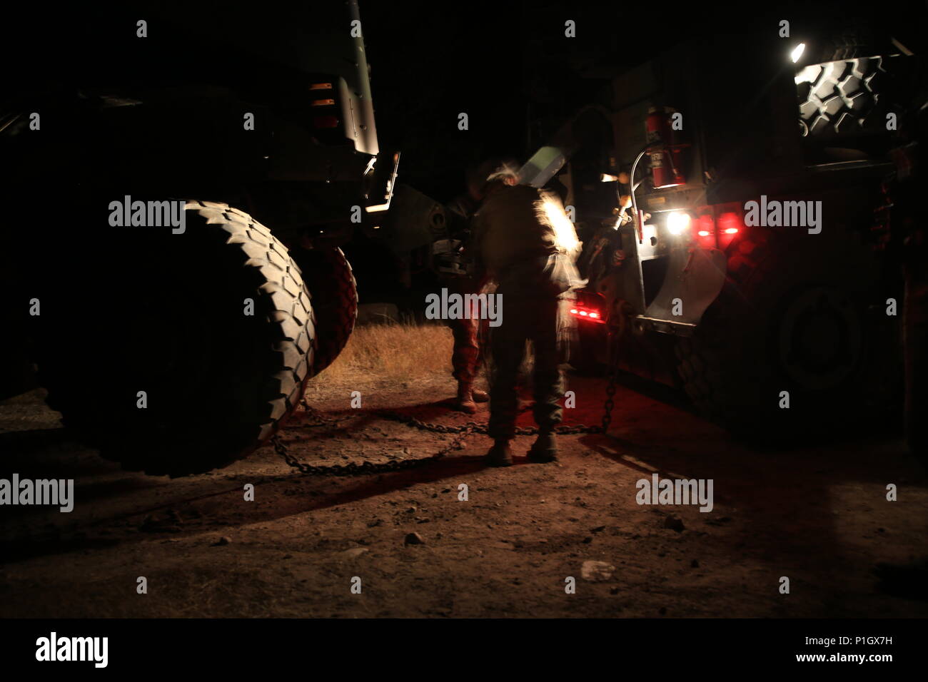 U.S. Marines Cpl. Jesse Gunderson and Lance Cpl. Juan Cerda attach tow ...