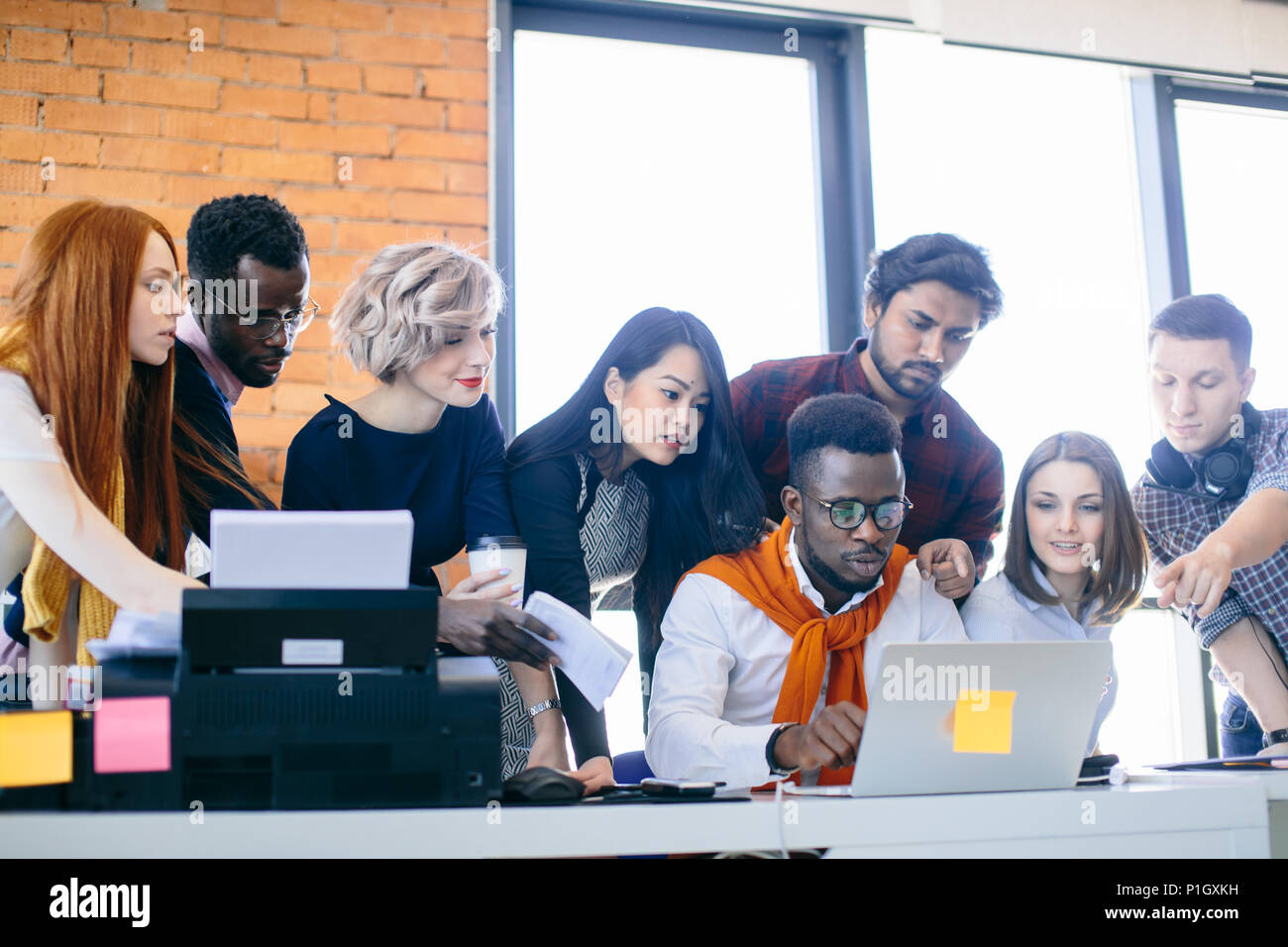 Group people sitting round table hi-res stock photography and images ...