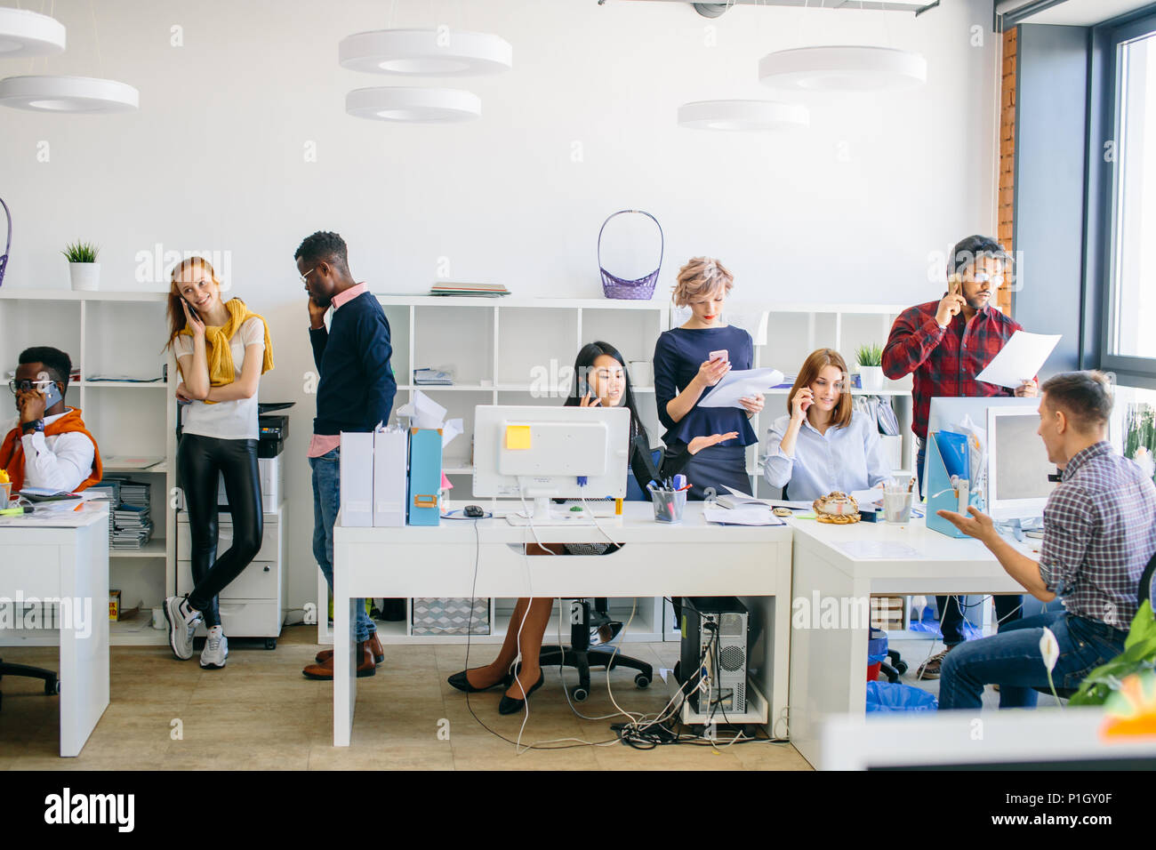 energetic office people are using mobile phones at work Stock Photo - Alamy