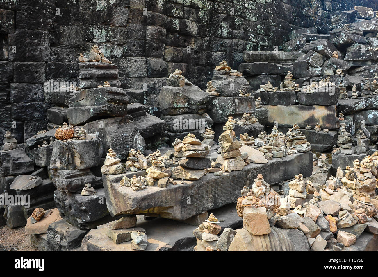 Stone marker cairns lie among the ruins of Bayon temple, Angkor complex ...