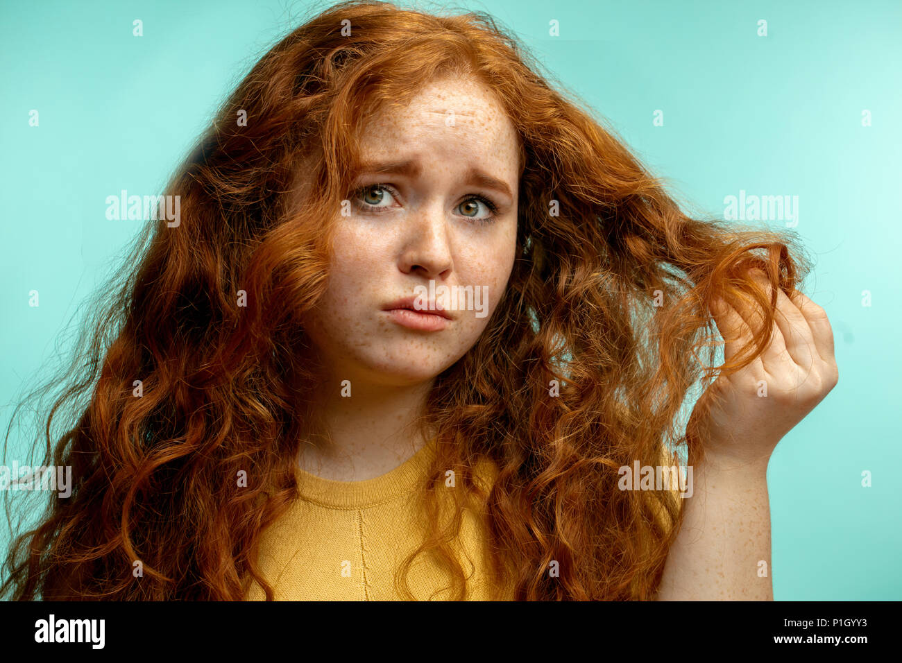 Upset and woman with her damaged dry hair face expression blue ...
