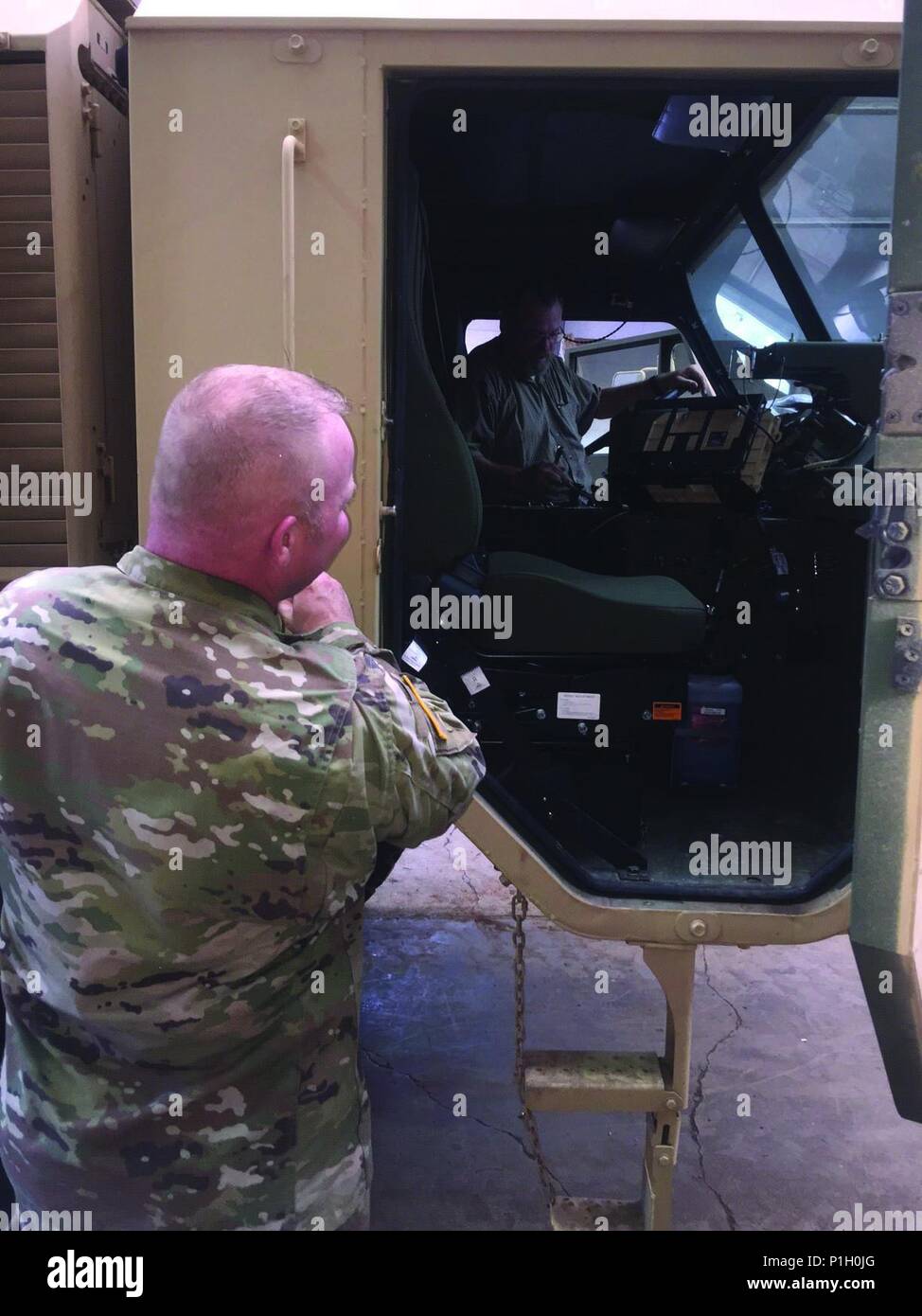 Rueben Cowell (seated in truck), a logistics management specialist in ...