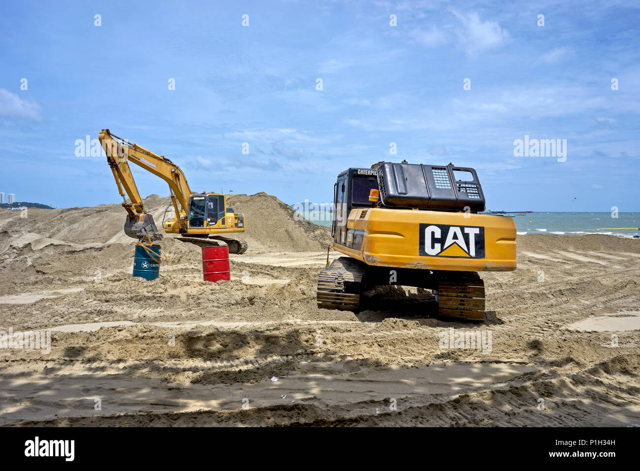 Backhoe working on the beach reclamation project at Pattaya Thailand ...