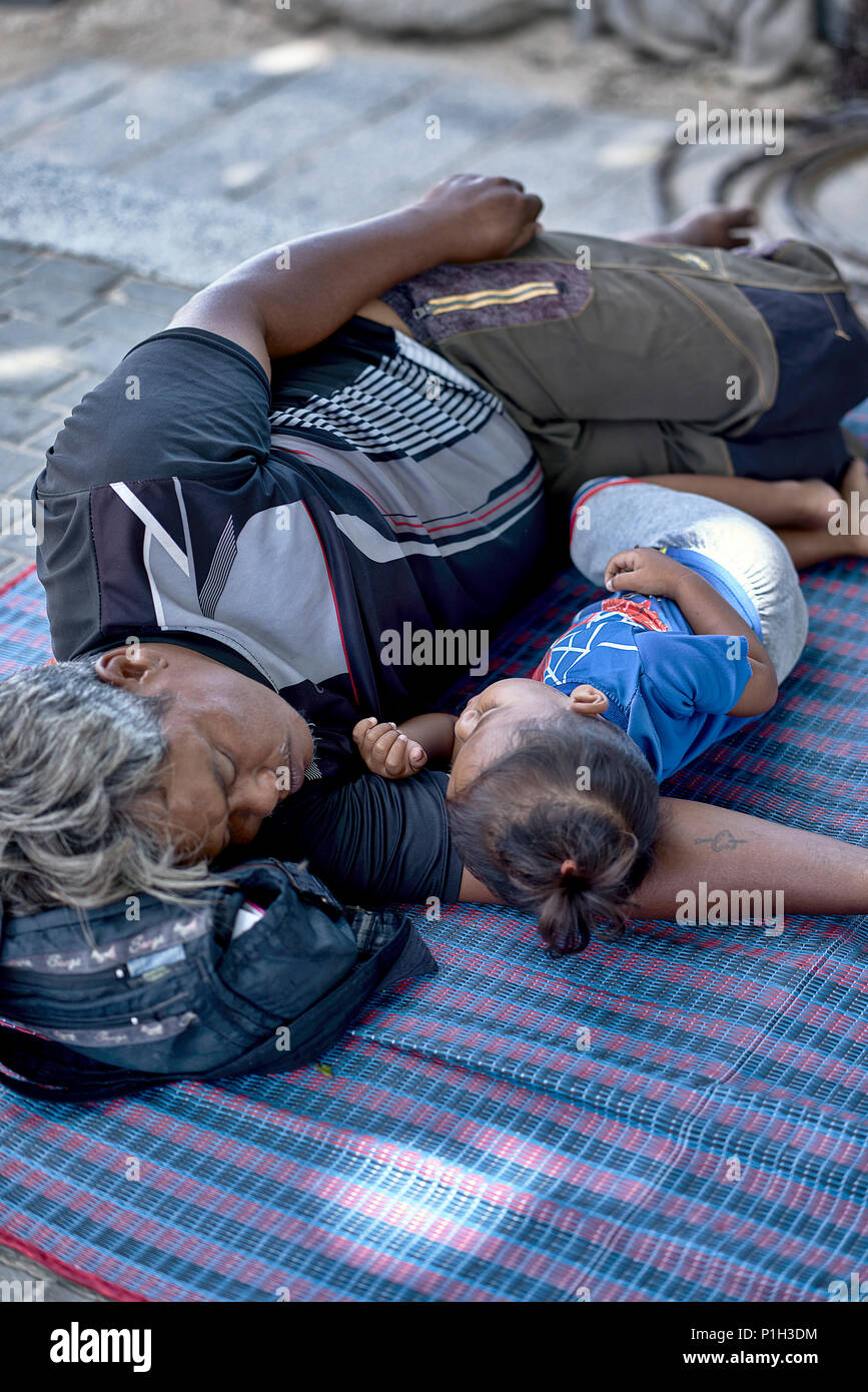 Father and child sleeping on a Thailand street Stock Photo - Alamy