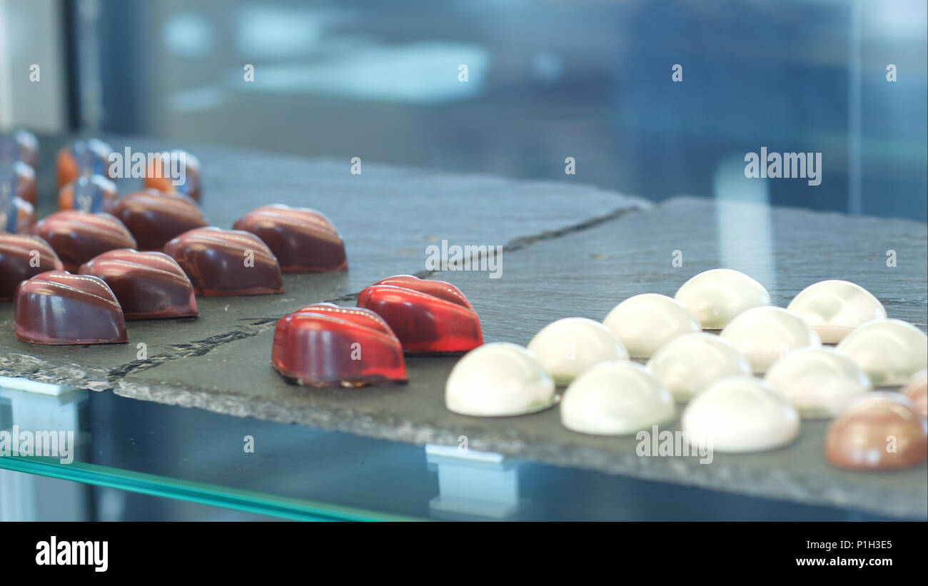 Shop window with stacks of chocolate sweets, jellies and candies Stock ...
