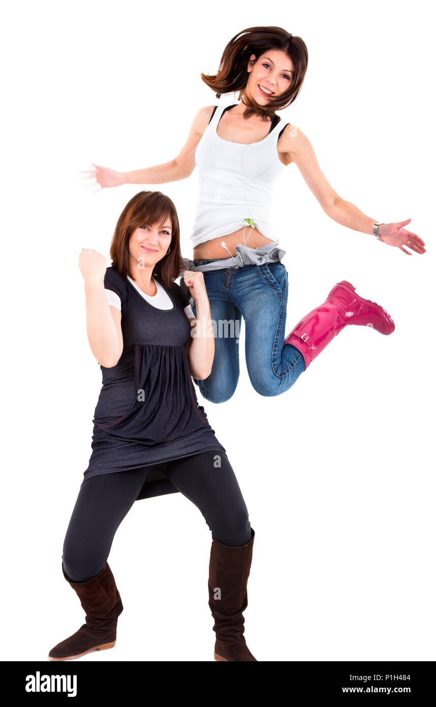 Two young happy women with smiling facial expression in action jumping ...