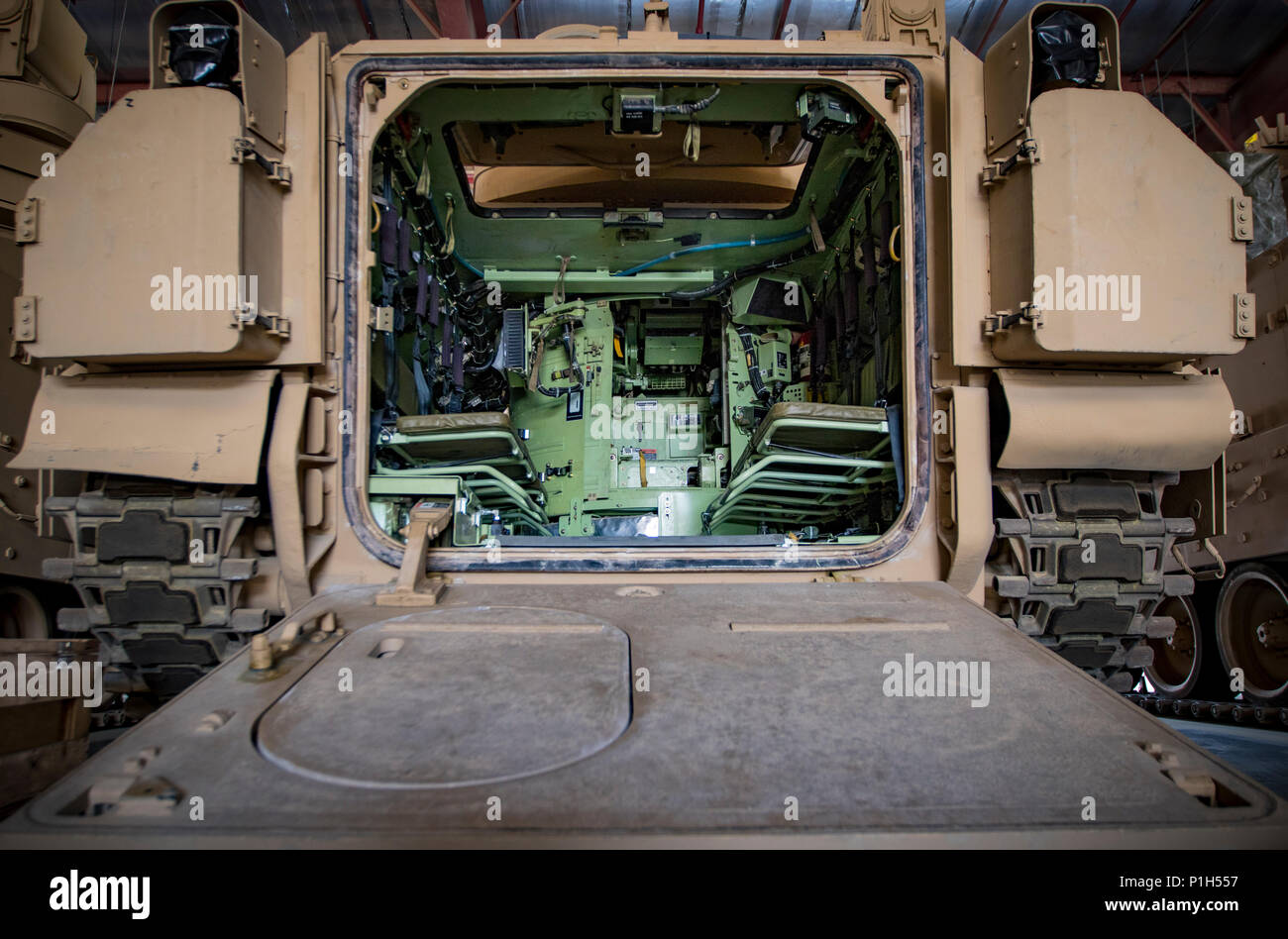 A Bradley Fighting Vehicle is prepositioned inside a warehouse ...