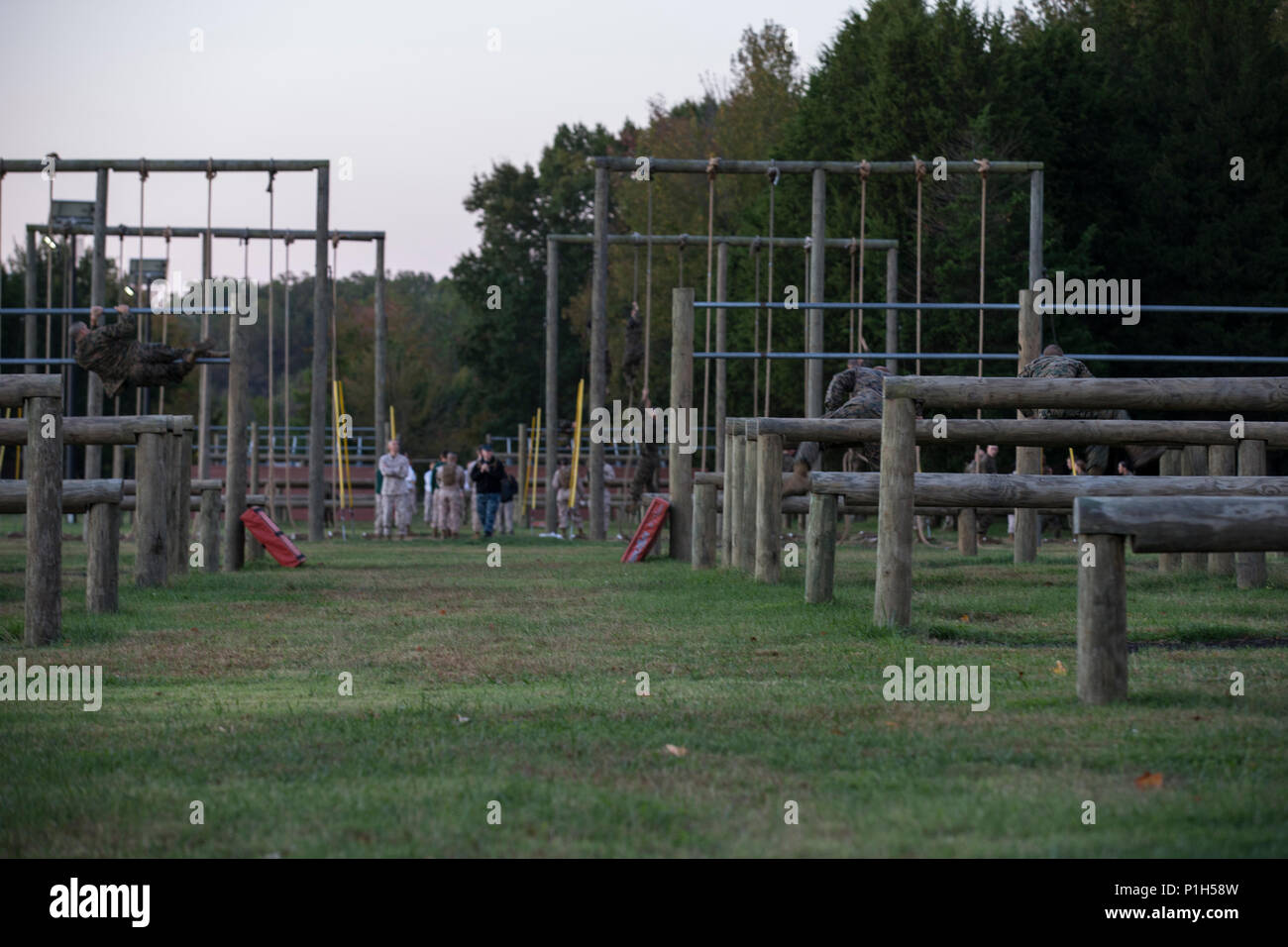 U.S. Marine candidates maneuver through the obstacle course while at ...