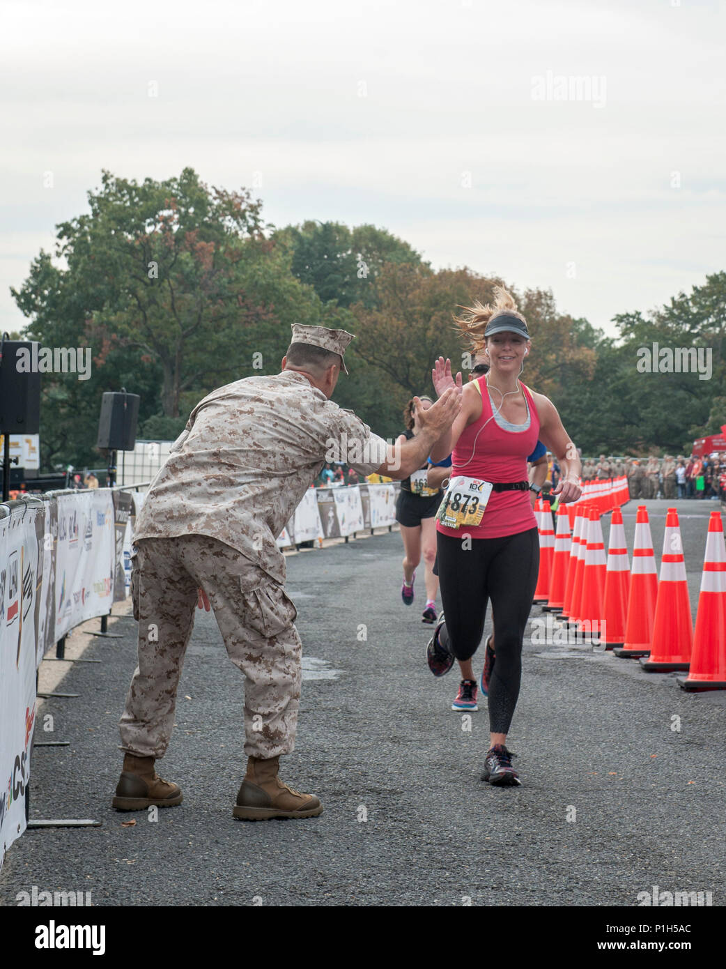 A runner high-fives U.S. Marine Corps Col. Joseph Murray, commanding ...