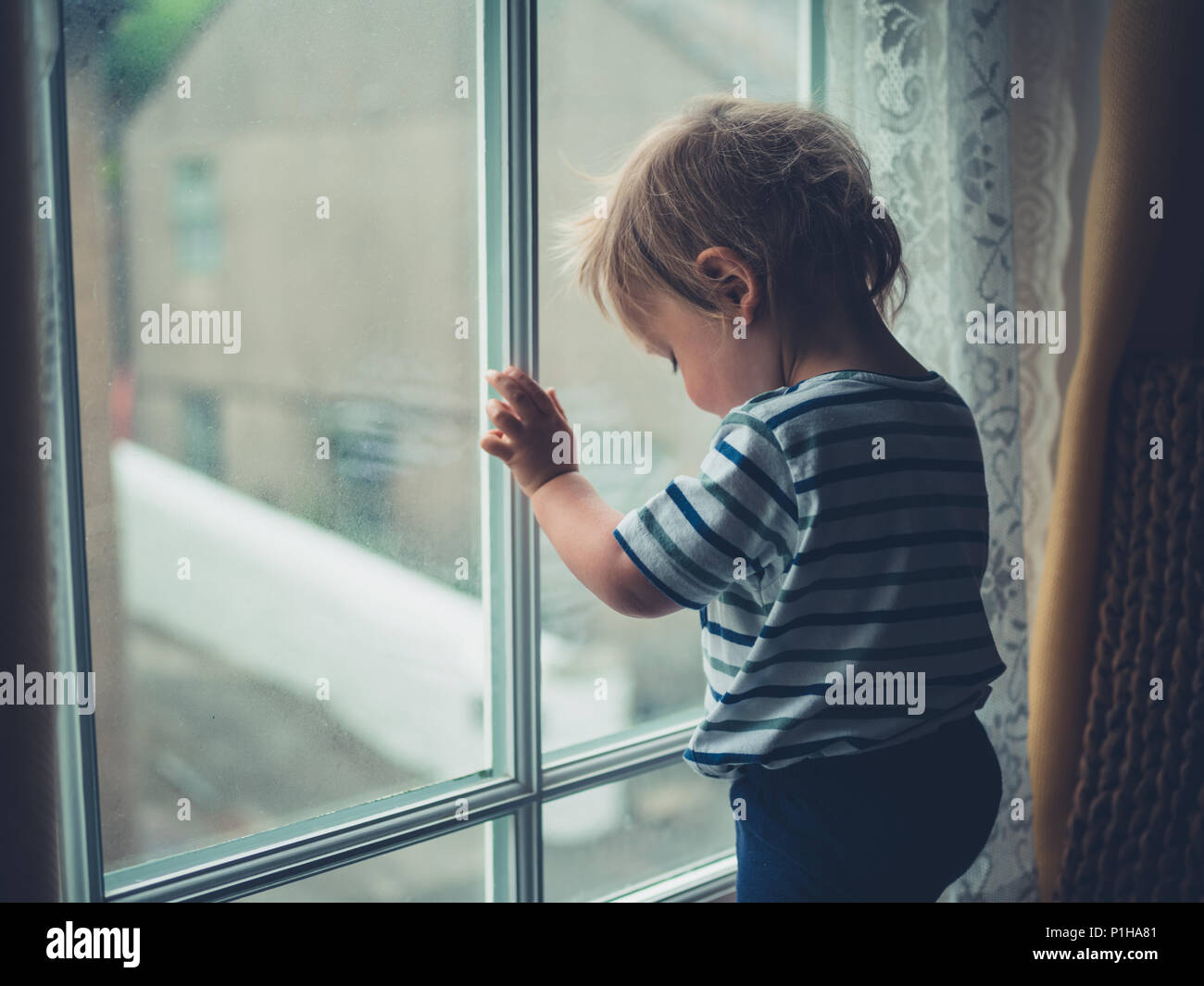 Child Looking Out Window Rainy Day High Resolution Stock Photography ...
