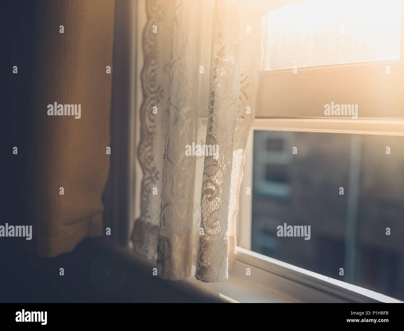 Afternoon sunlight hitting a curtain through the window Stock Photo - Alamy