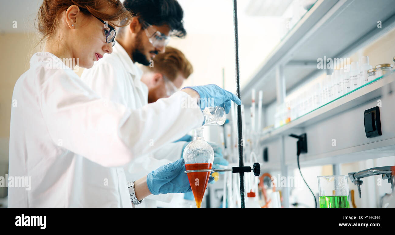 Group of chemistry students working in laboratory Stock Photo - Alamy